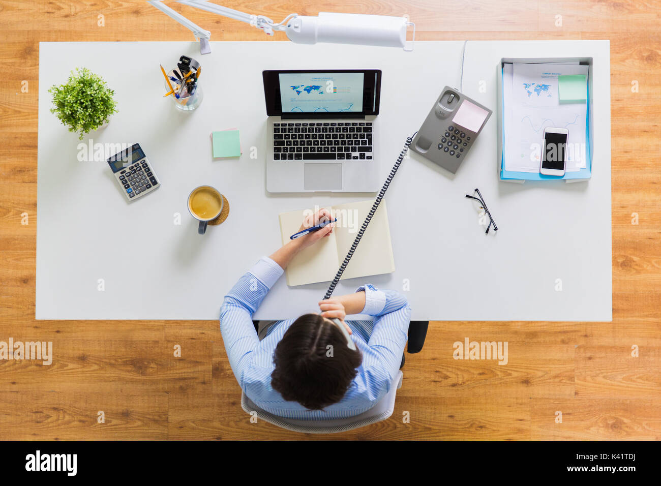 businesswoman calling on phone at office table Stock Photo - Alamy