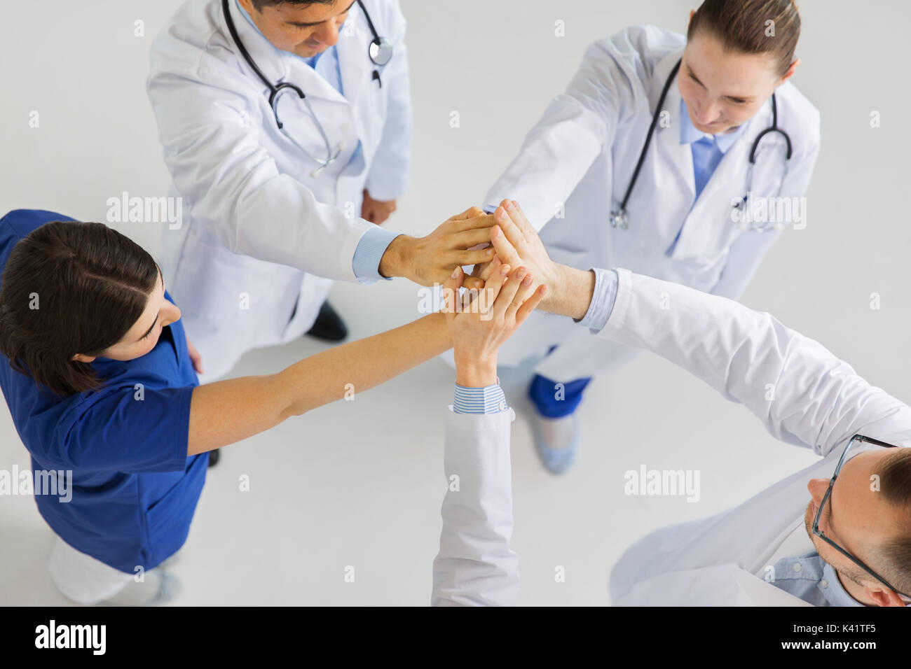 group of doctors making high five at hospital Stock Photo - Alamy
