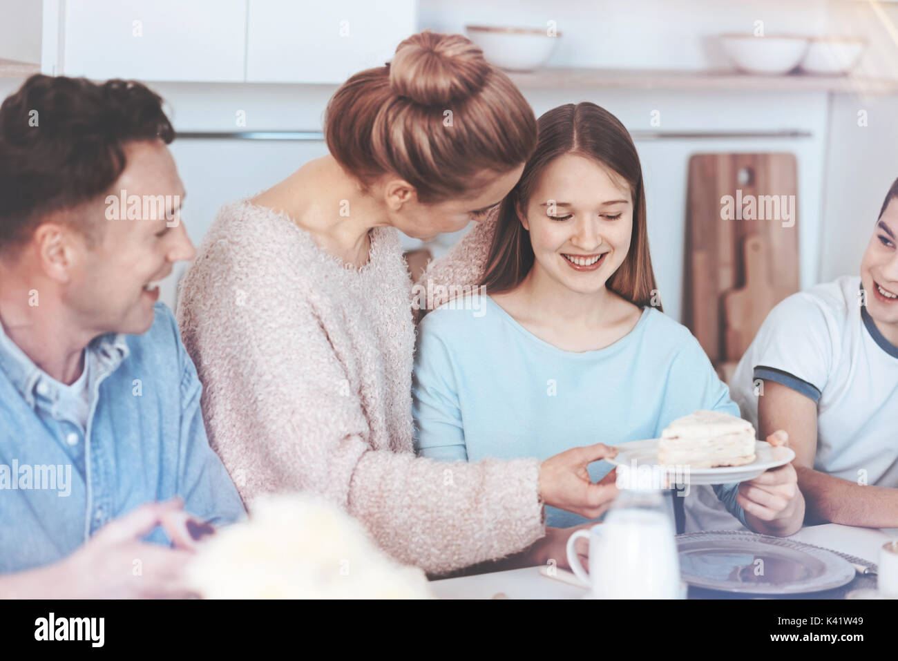 Mindful mother entertaining family with sweetest cake Stock Photo - Alamy