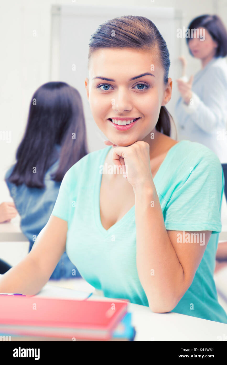 happy smiling student girl with books at school Stock Photo - Alamy