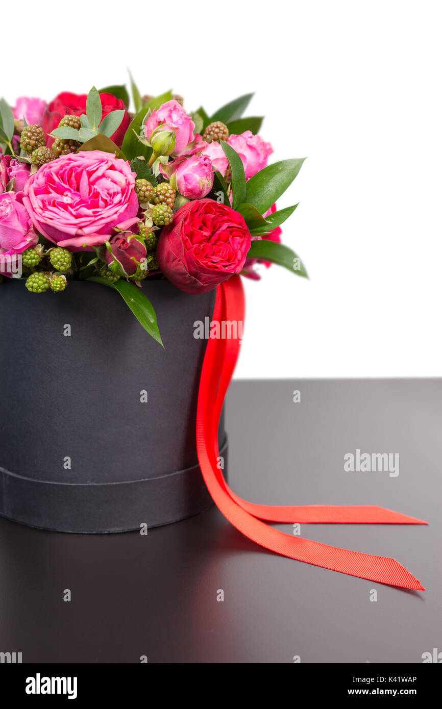 Stylish bouquet of pink roses and red ribbon in a concept of love ...