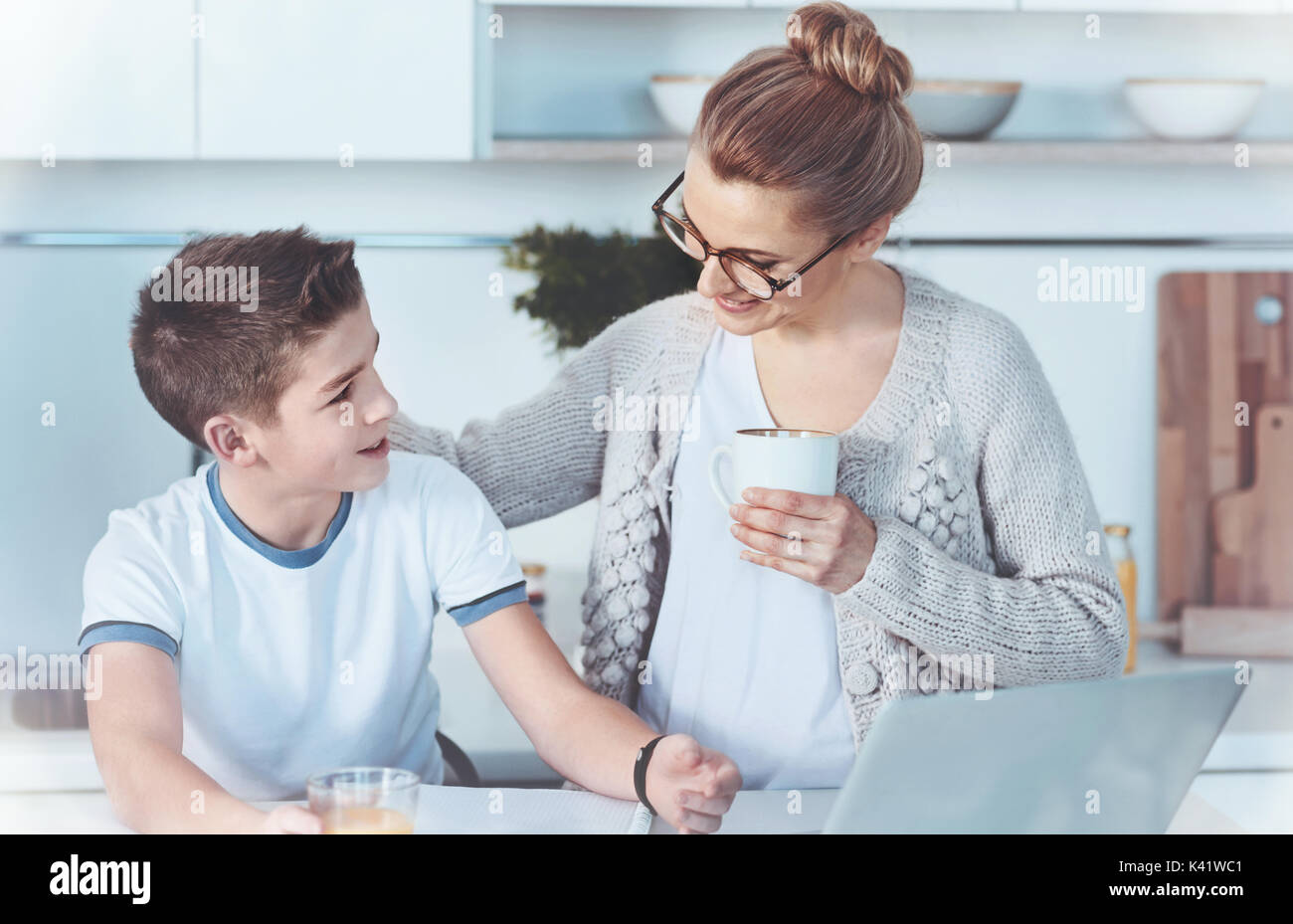 Smart boy asking mom for help with home assignment Stock Photo - Alamy