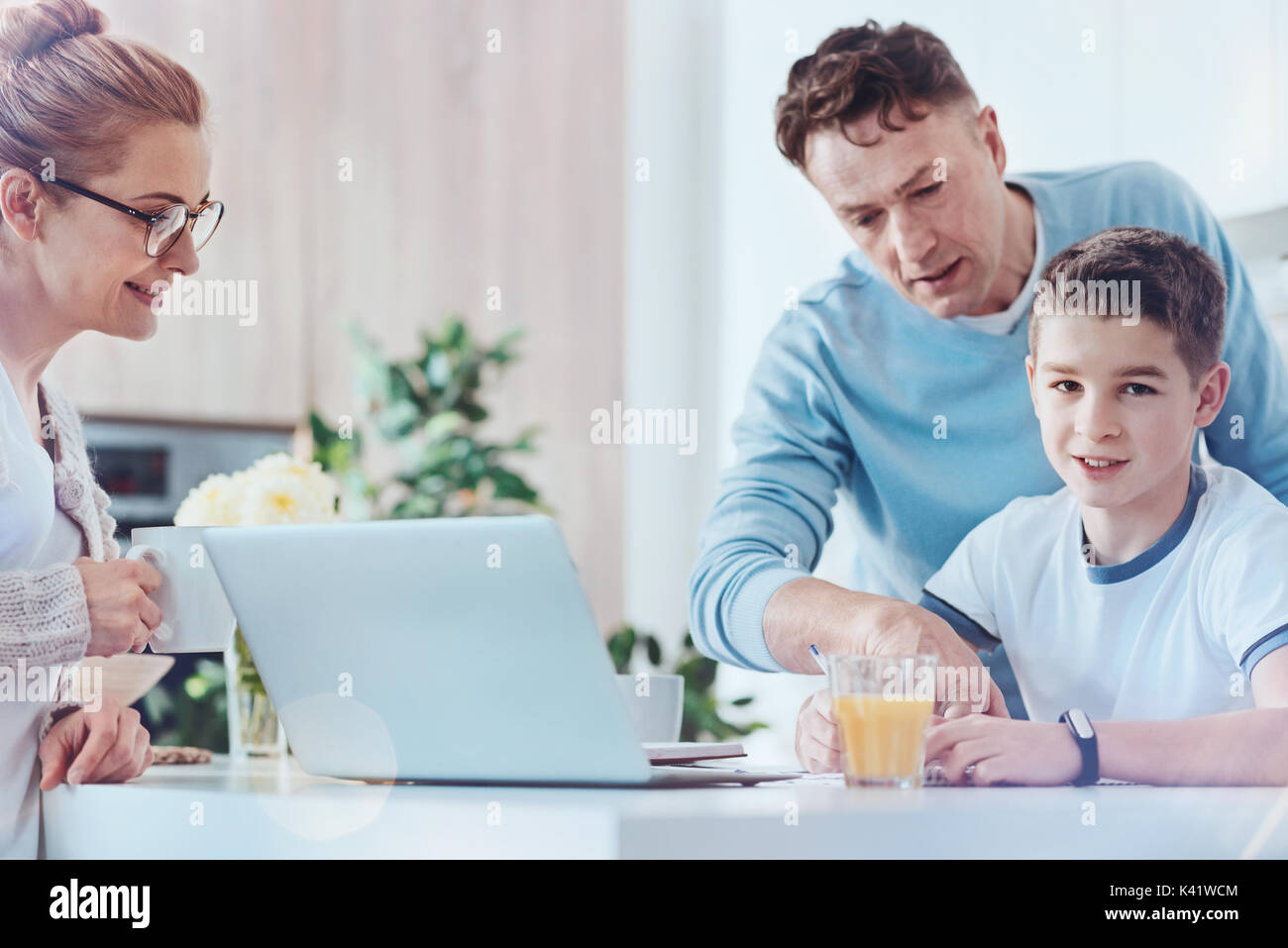 Loving parents helping their son with school project Stock Photo - Alamy