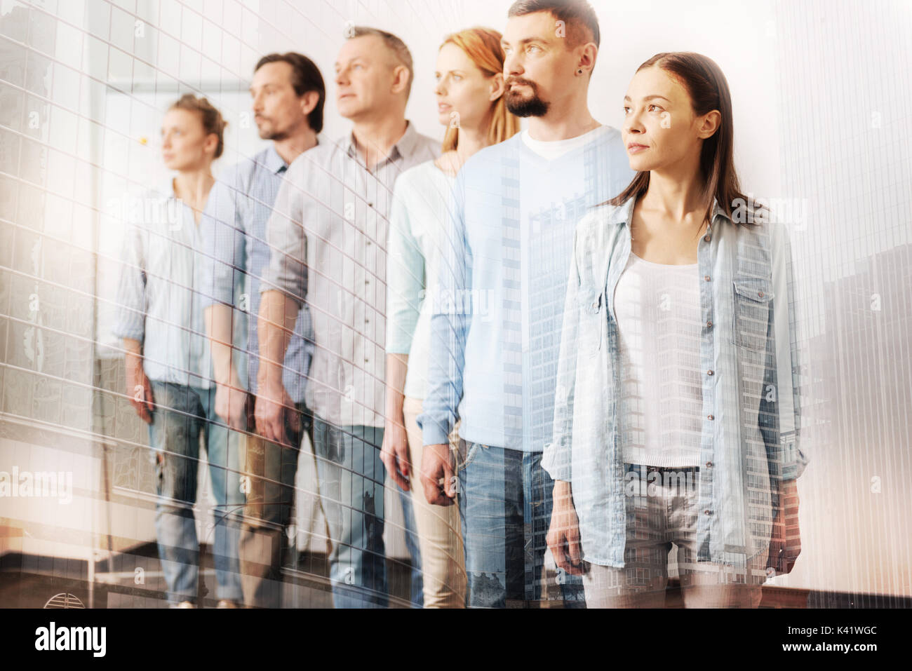 Group of serious people standing in one row Stock Photo - Alamy
