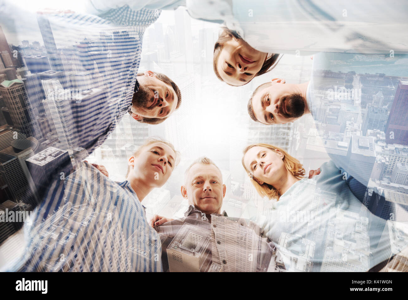 Low angle of a friendly team of office workers bonding to each other ...