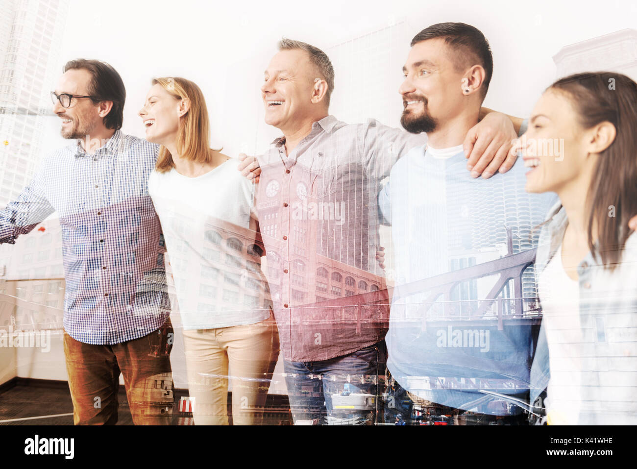 Joyful office workers standing in the office Stock Photo - Alamy