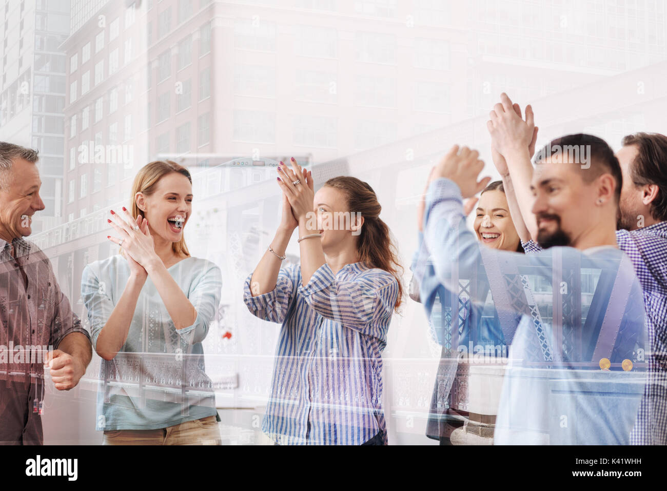 Overjpyed office workers clapping their hands Stock Photo - Alamy