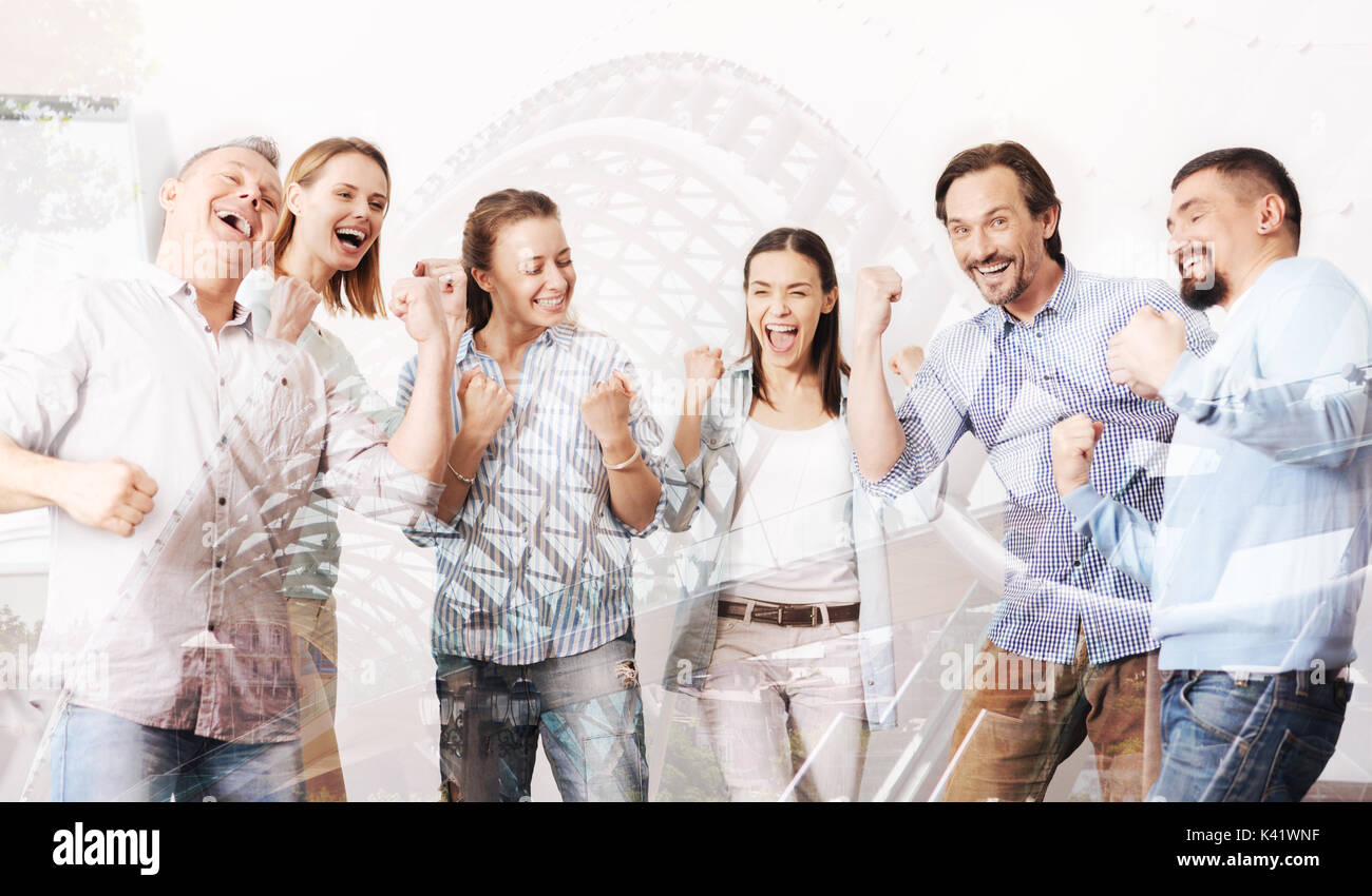 Positive colleagues celebrating a successful project Stock Photo - Alamy