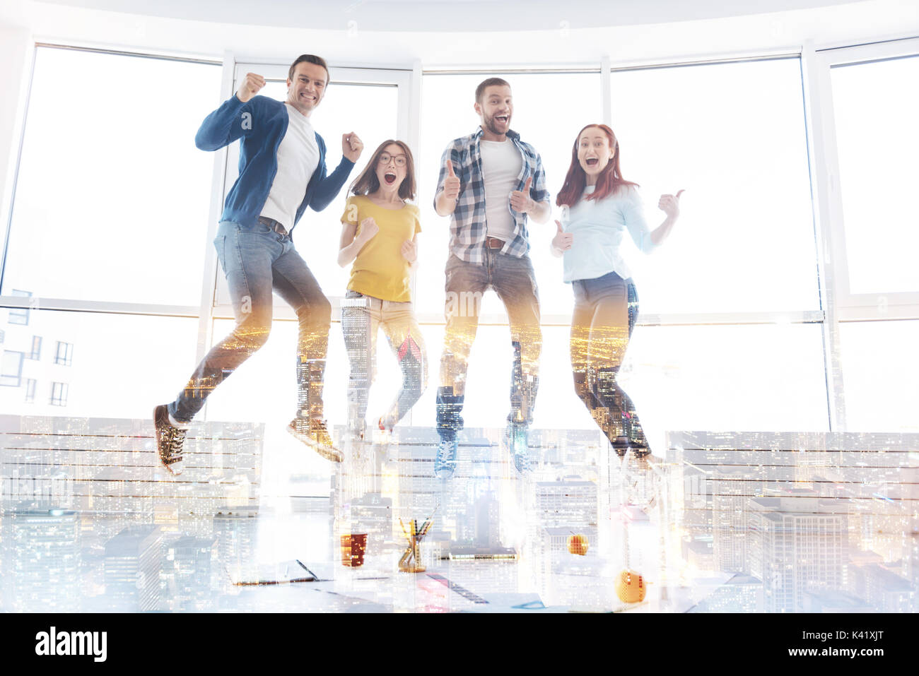 Smart cheerful students jumping together Stock Photo - Alamy