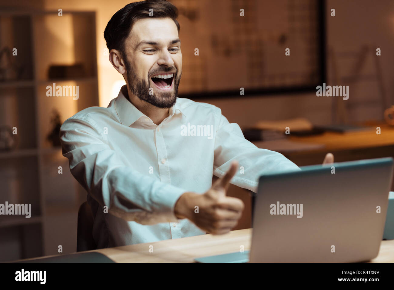 Delighted young start-upper feeling happiness Stock Photo - Alamy