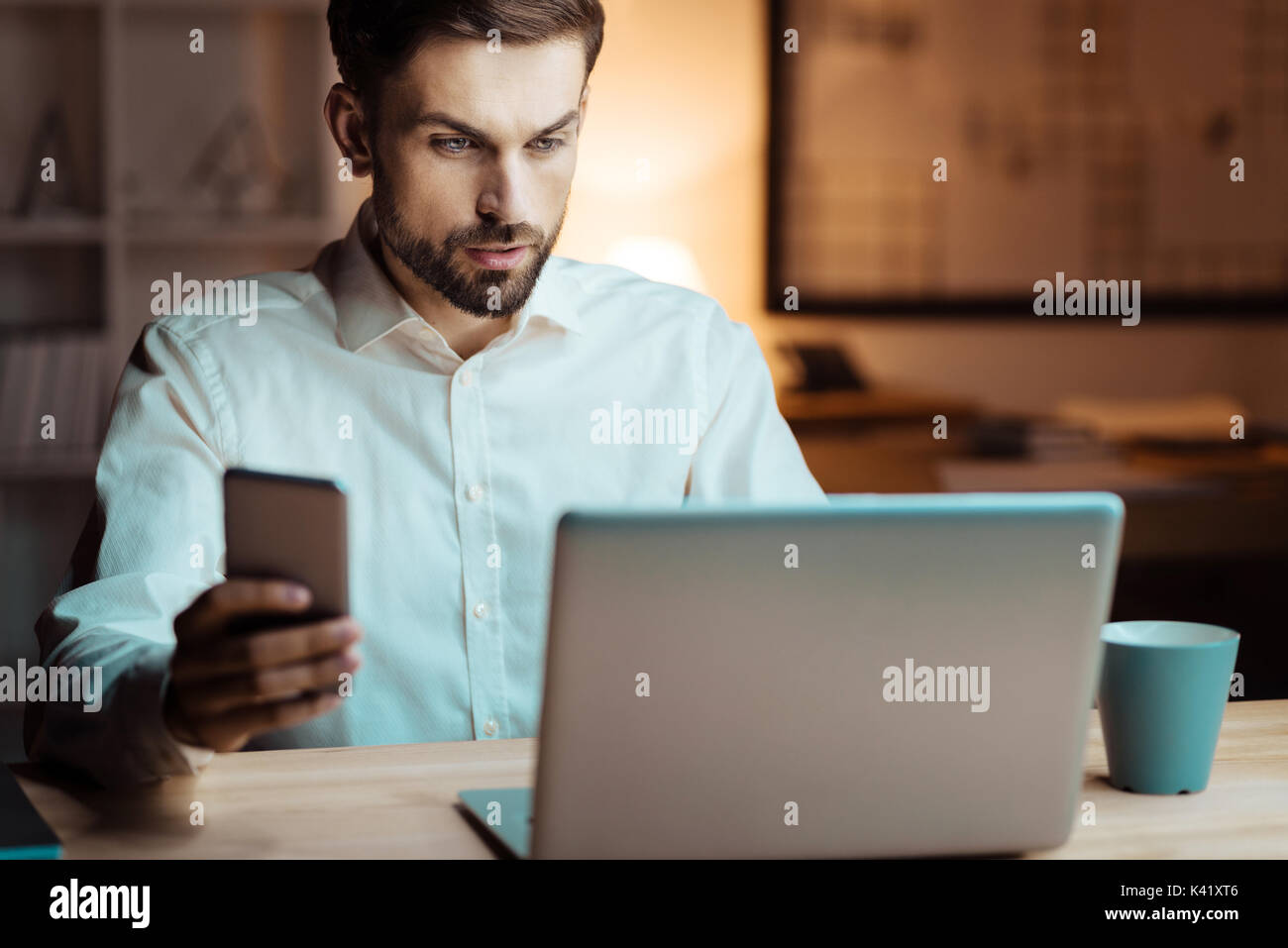 Serious man looking at his computer Stock Photo - Alamy