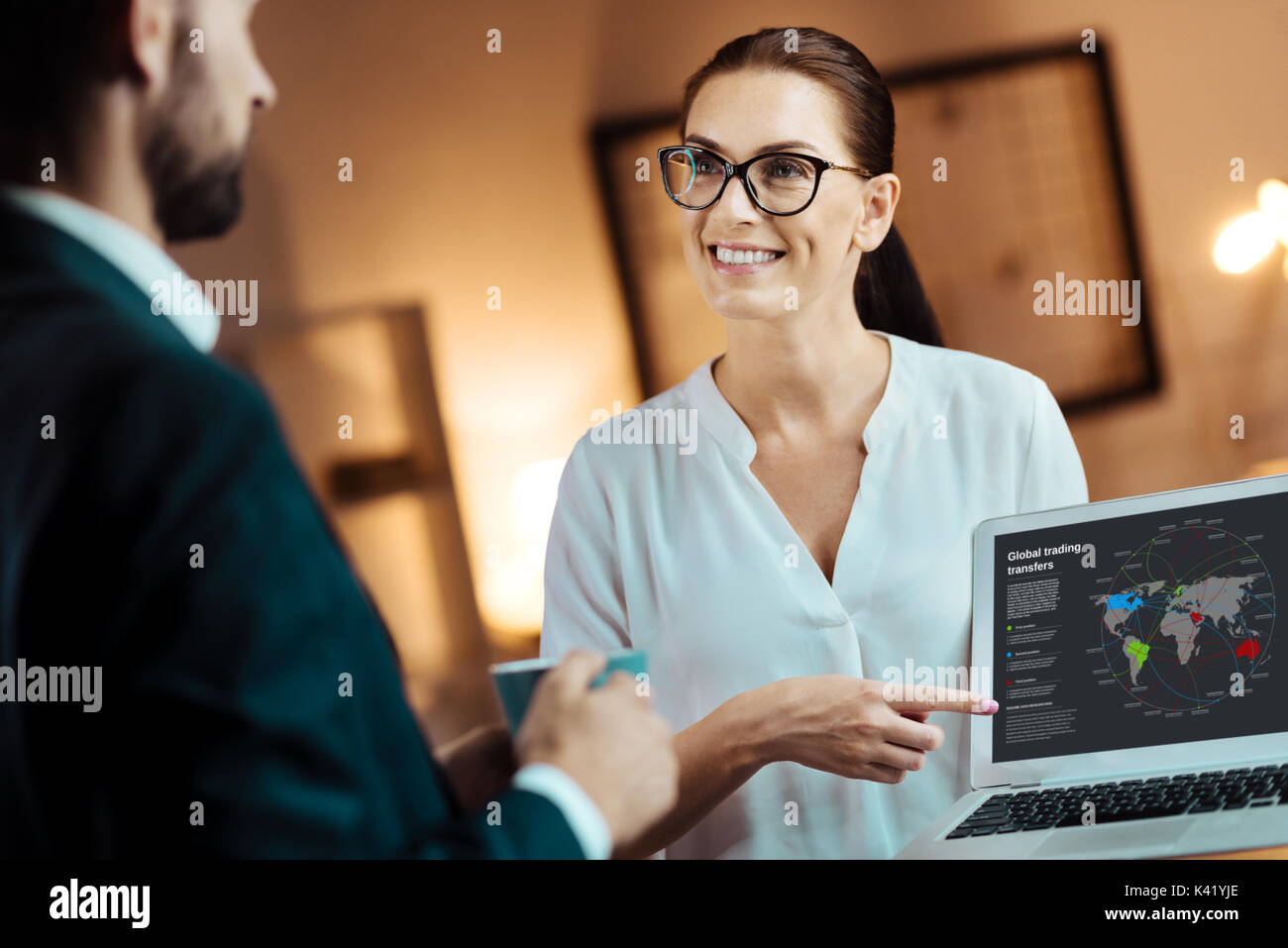 Cheerful female showing her presentation Stock Photo - Alamy
