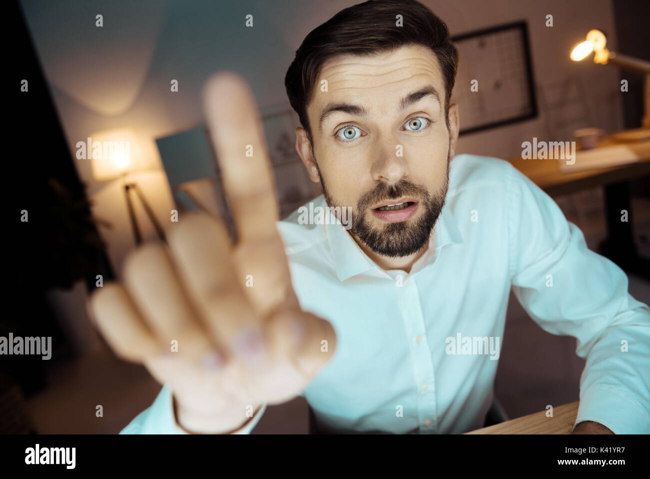 Surprised male person looking at camera Stock Photo - Alamy