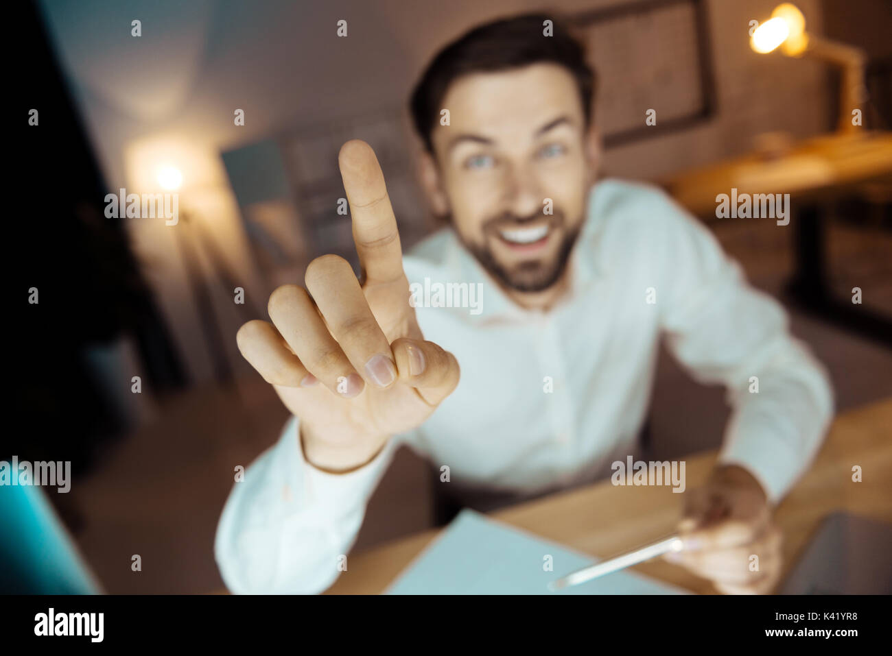 Joyful man looking at his finger Stock Photo - Alamy