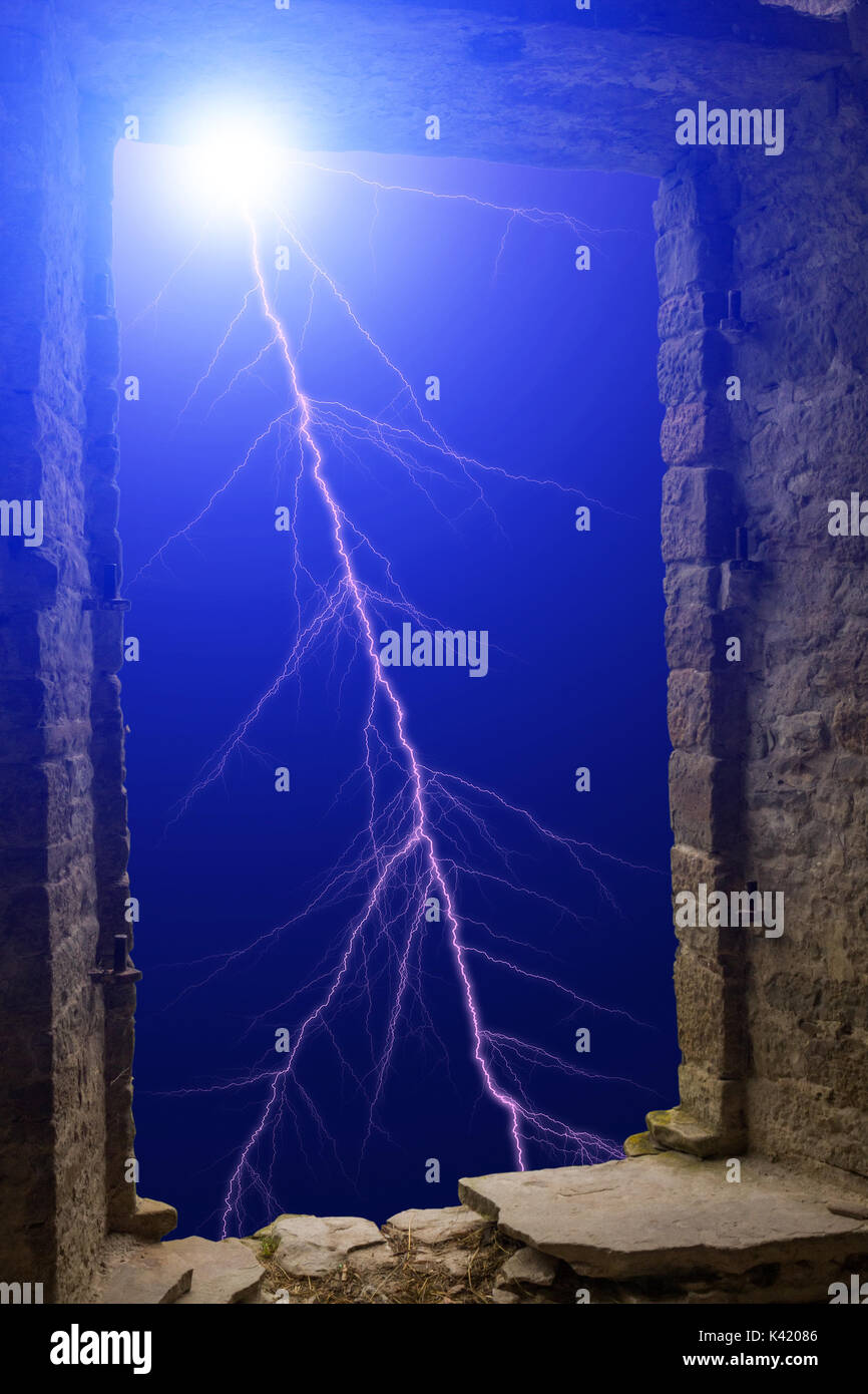 Bolt of lightning on the dark blue sky background visible through old ...