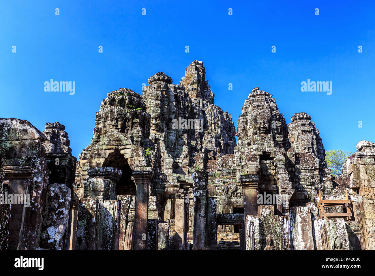 Giant stone faces of ancient buddhist khmer Bayon temple in Angkor Thom, Siem Reap, Cambodia ...