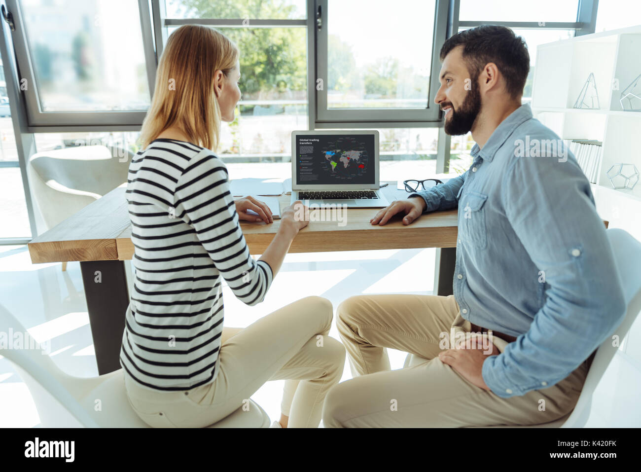 Young office workers discussing their common project Stock Photo - Alamy