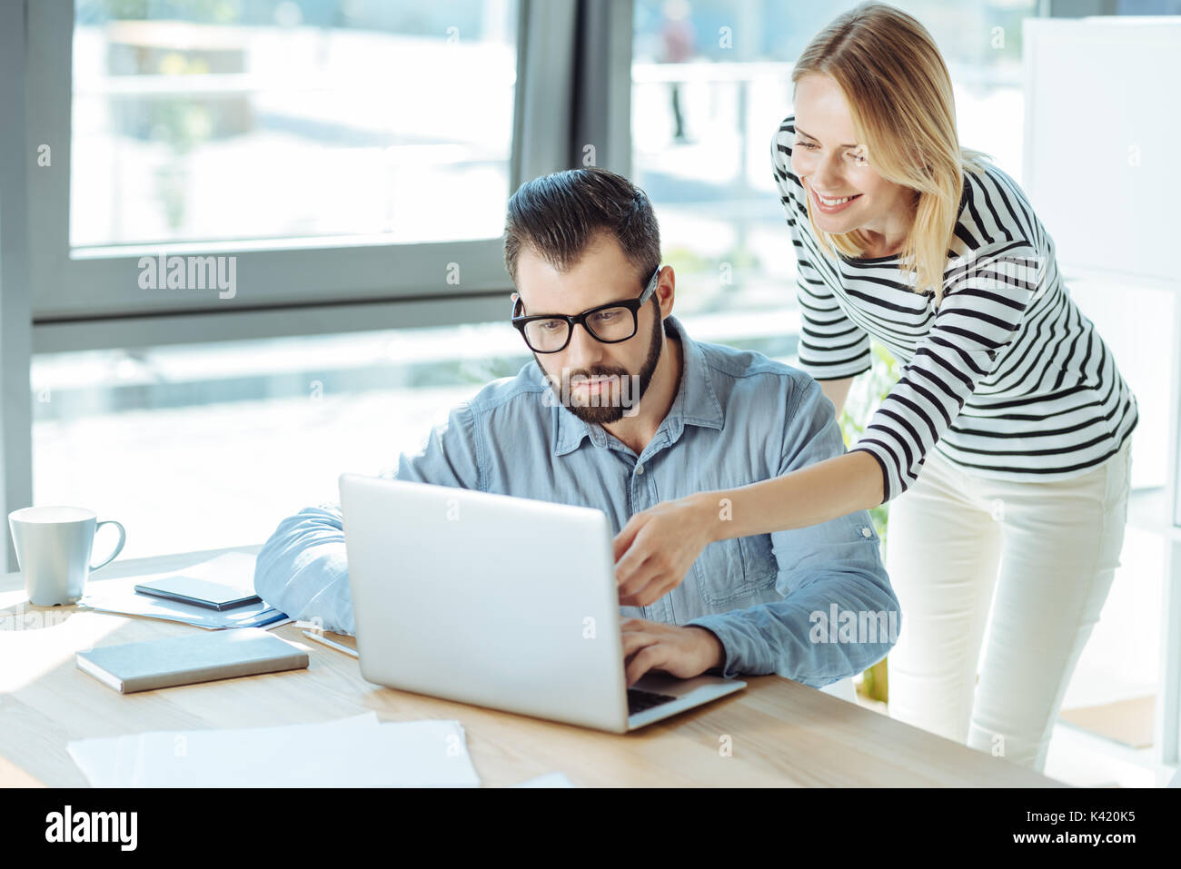 Pleasant woman giving advice to her male colleague Stock Photo - Alamy