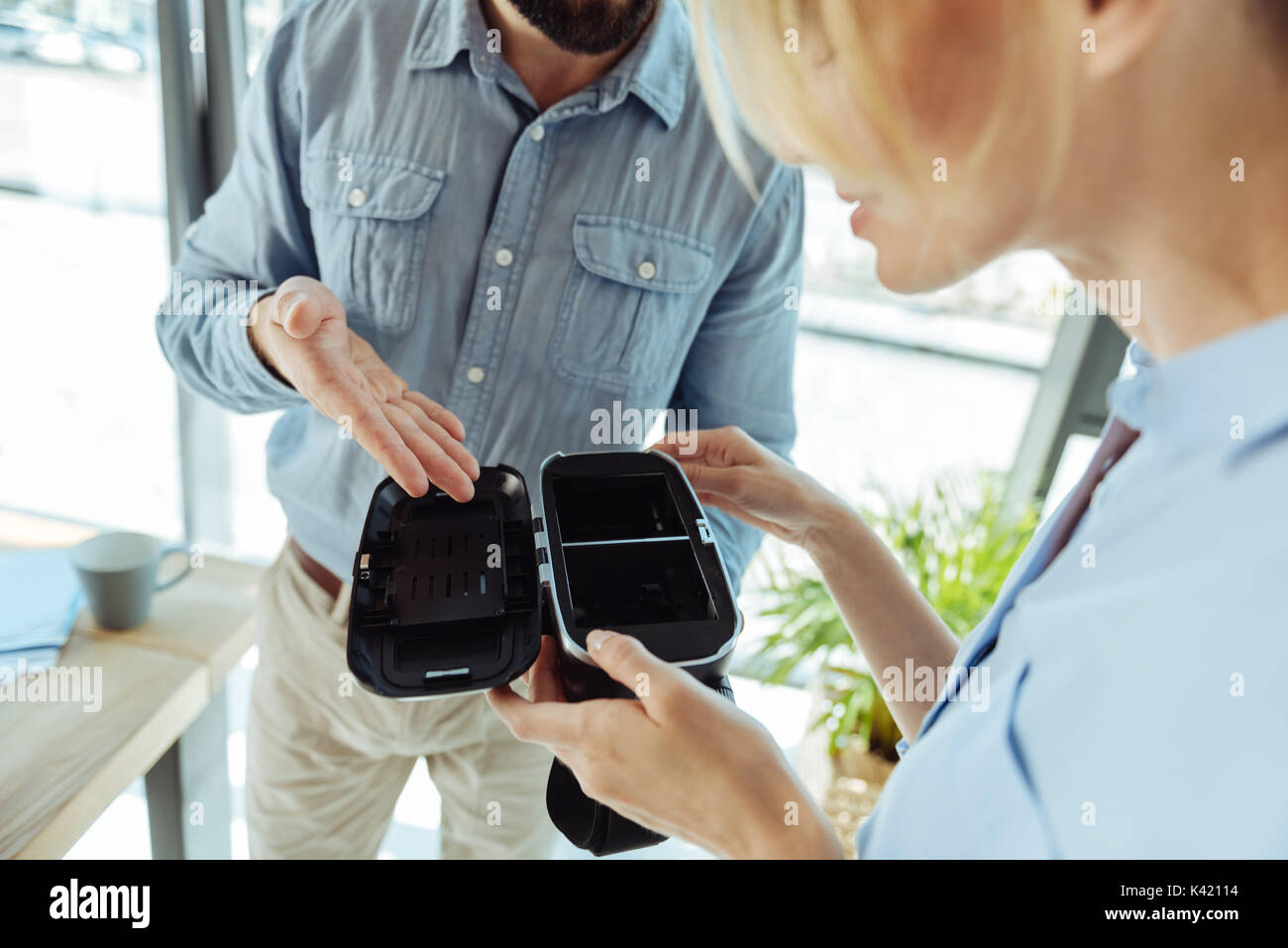 Two colleagues removing front lid of VR headset Stock Photo - Alamy