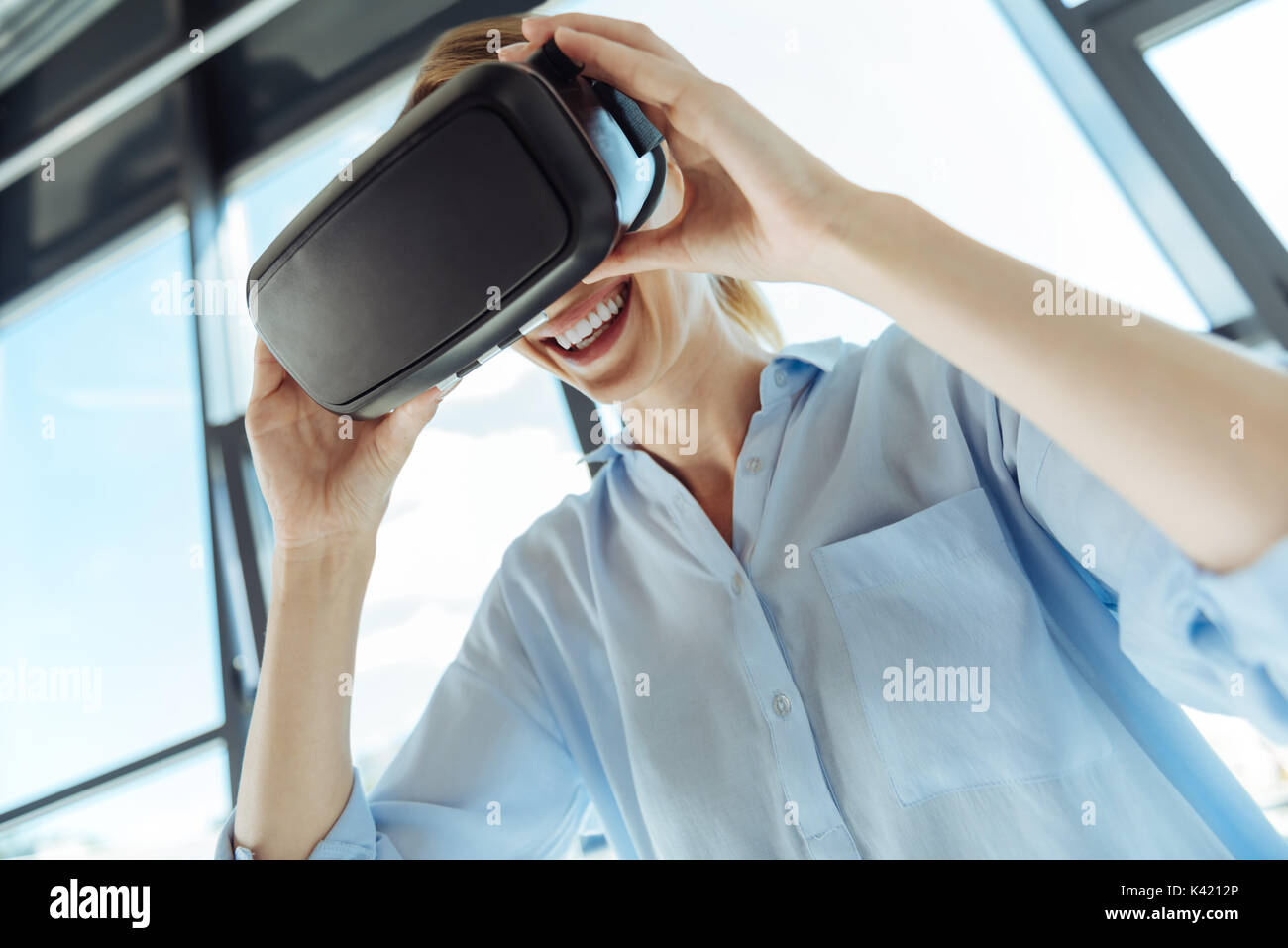 Cheerful young woman wearing a VR headset Stock Photo - Alamy