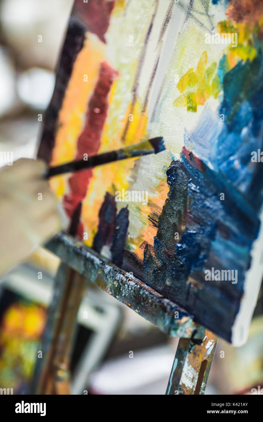 artist's hand with brush painting on canvas Stock Photo - Alamy