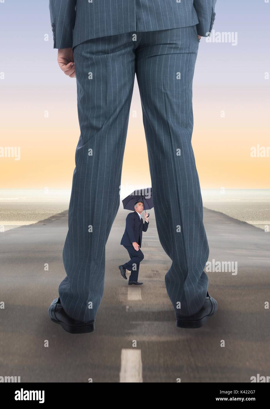 Digital composite of Scared small business man looking at a big ...