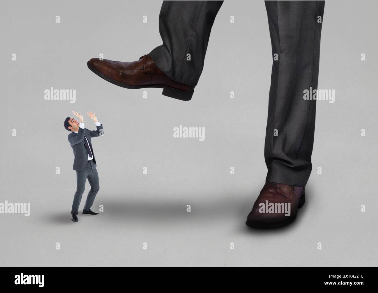 Digital composite of Scared small business man looking at a big ...