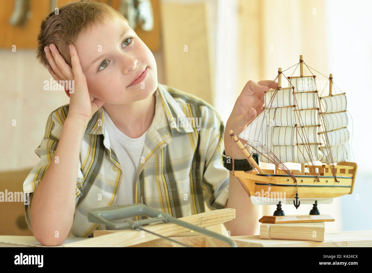 boy with model of ship and handsaw Stock Photo - Alamy