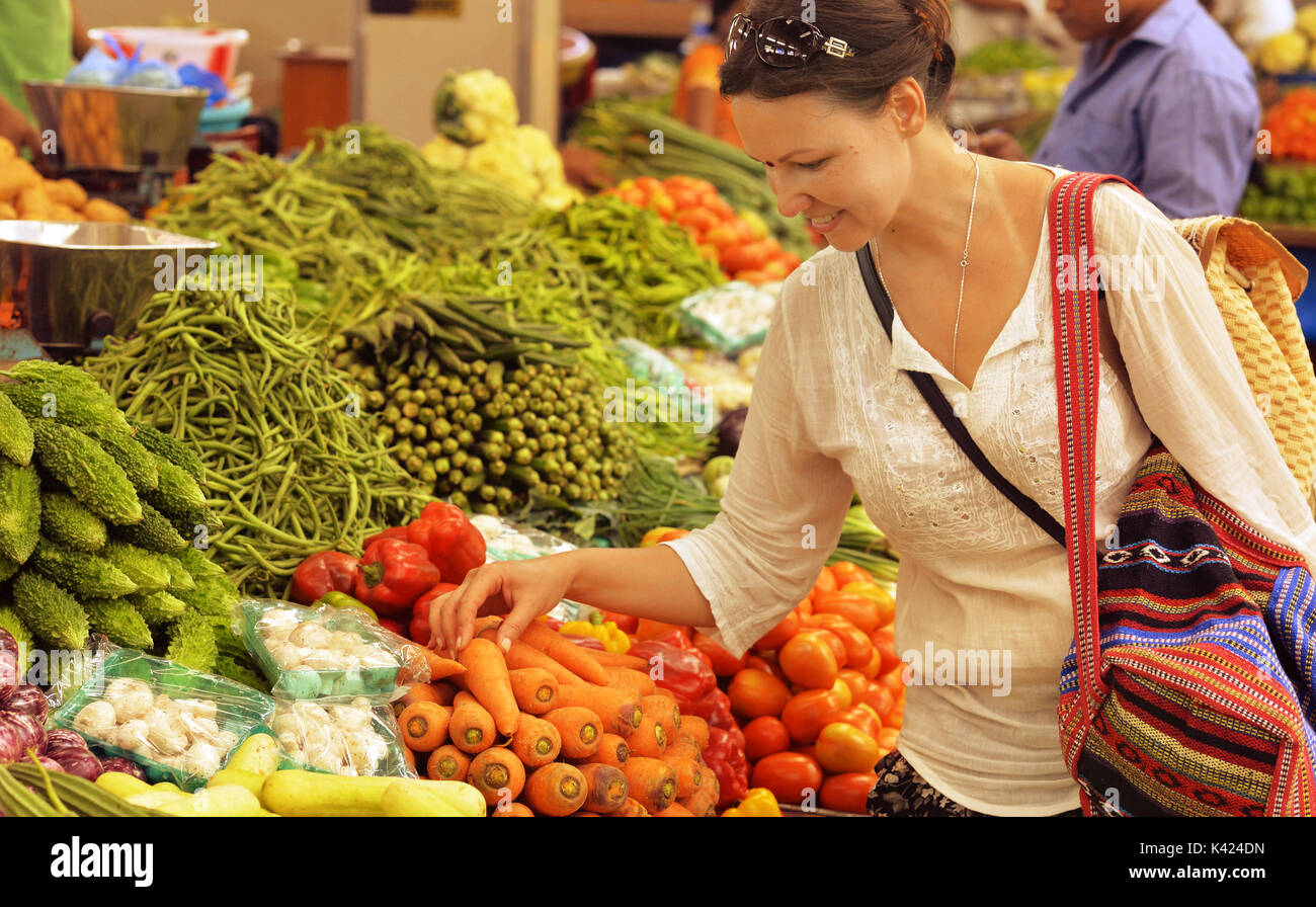Young woman choosing vegetables Stock Photo - Alamy