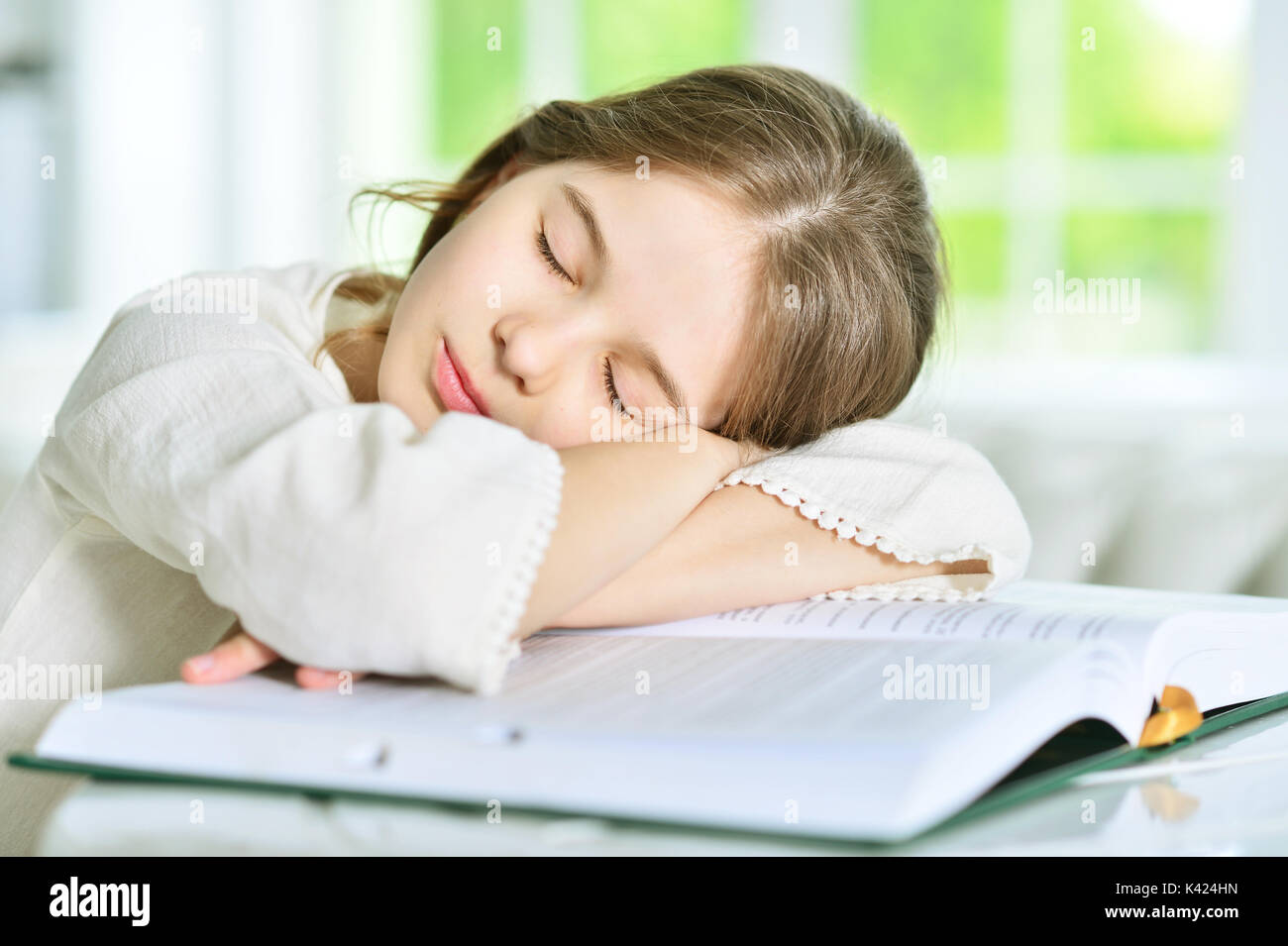 girl falling asleep on book Stock Photo - Alamy
