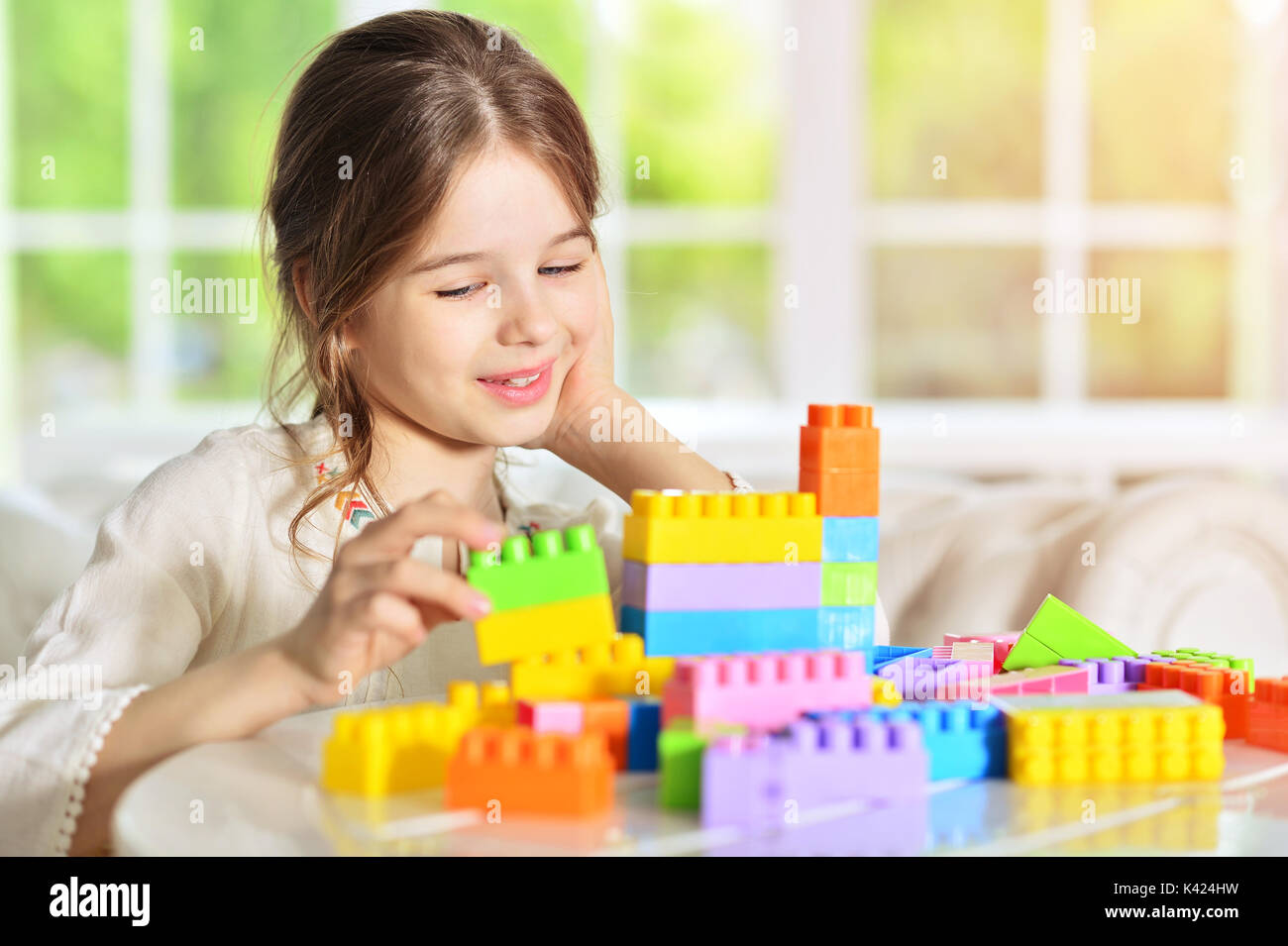 Cute girl playing with blocks Stock Photo - Alamy