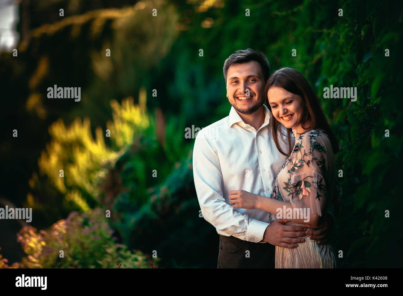Beautiful young couple on a nature background Stock Photo - Alamy