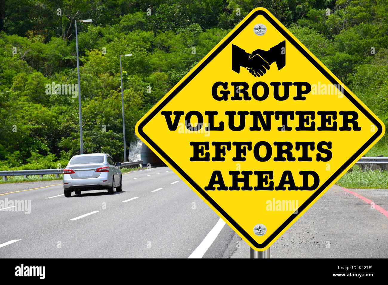 Group volunteer Efforts Ahead, yellow warning road sign Stock Photo - Alamy