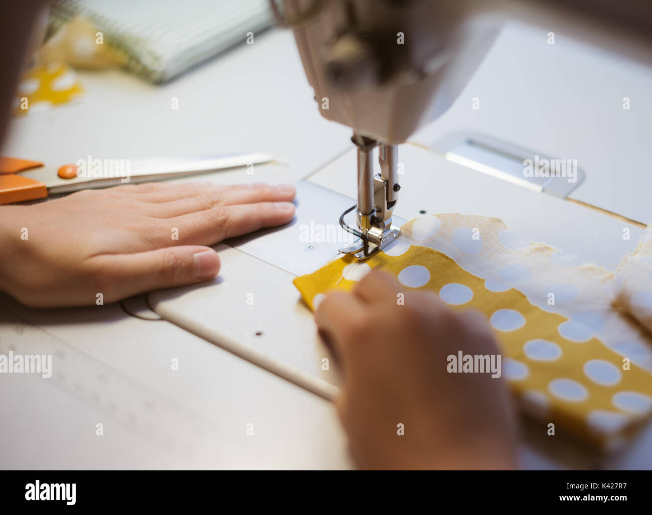 Little girl working on sewing machine at home. Close-up view Stock ...