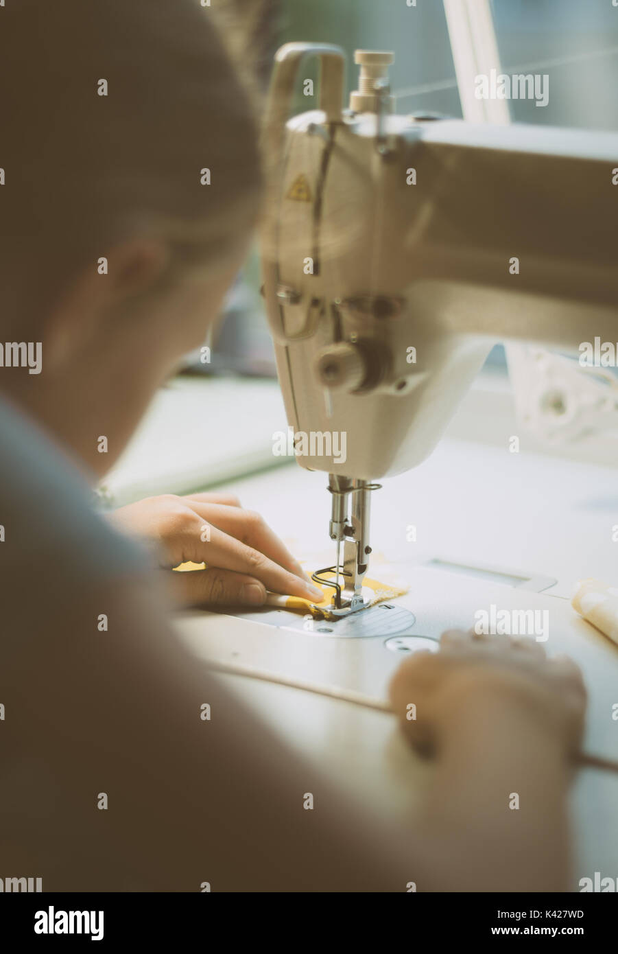 Little girl working on sewing machine at home. Close-up view Stock ...