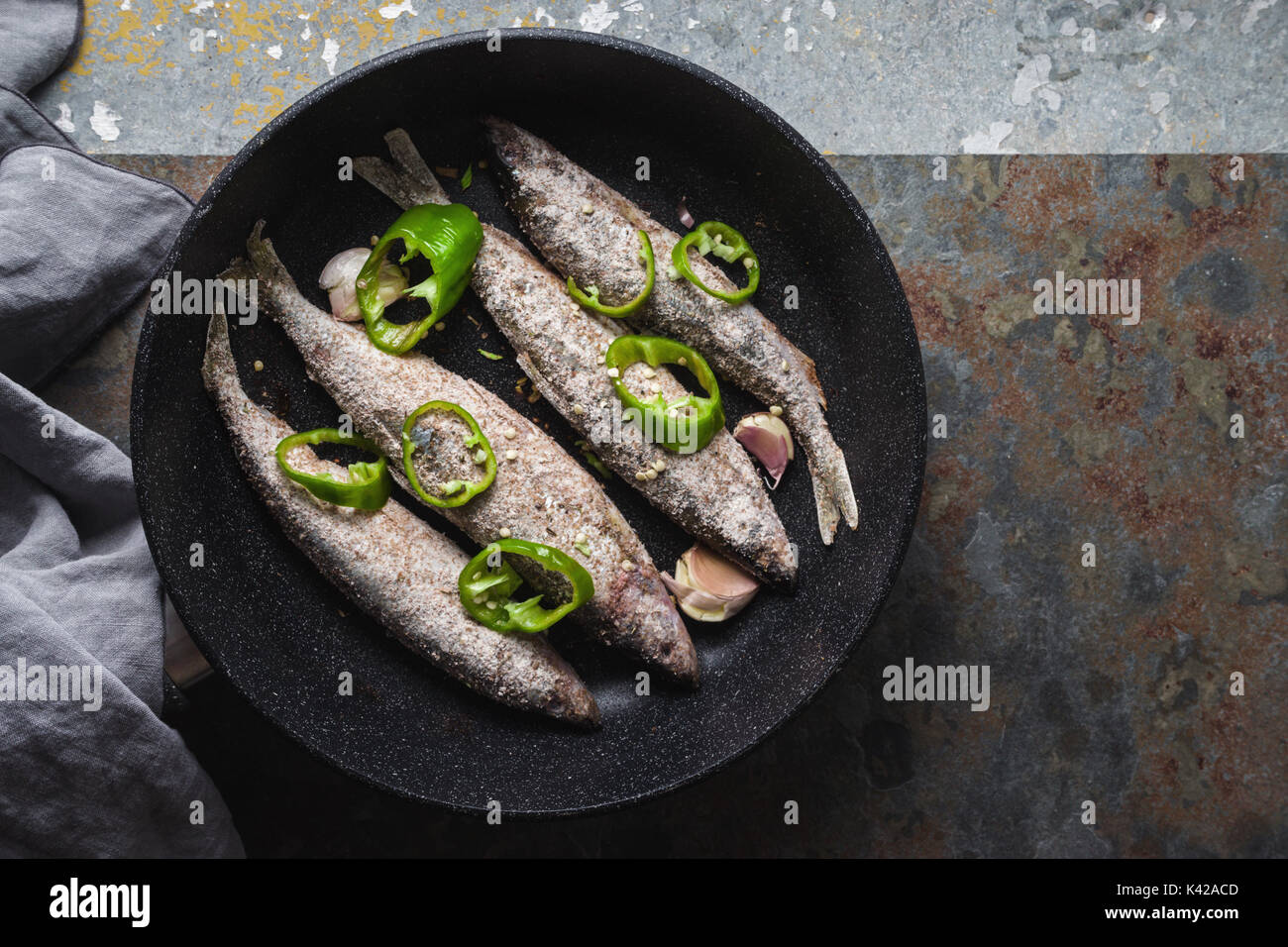 Fish, chili and garlic in a frying pan horizontal Stock Photo - Alamy
