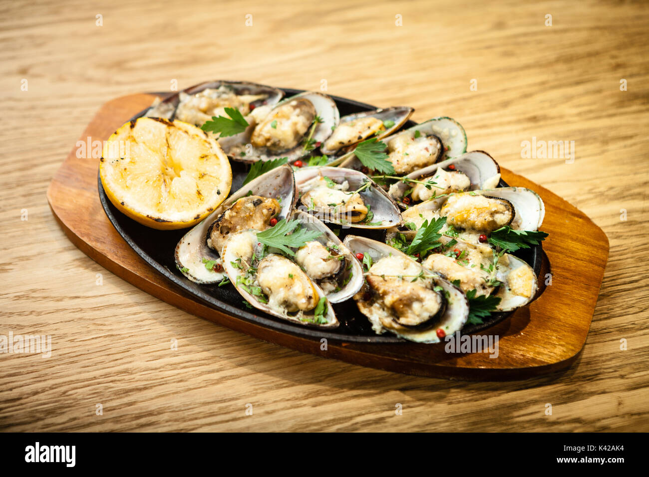 Baked mussels with cheese Stock Photo - Alamy