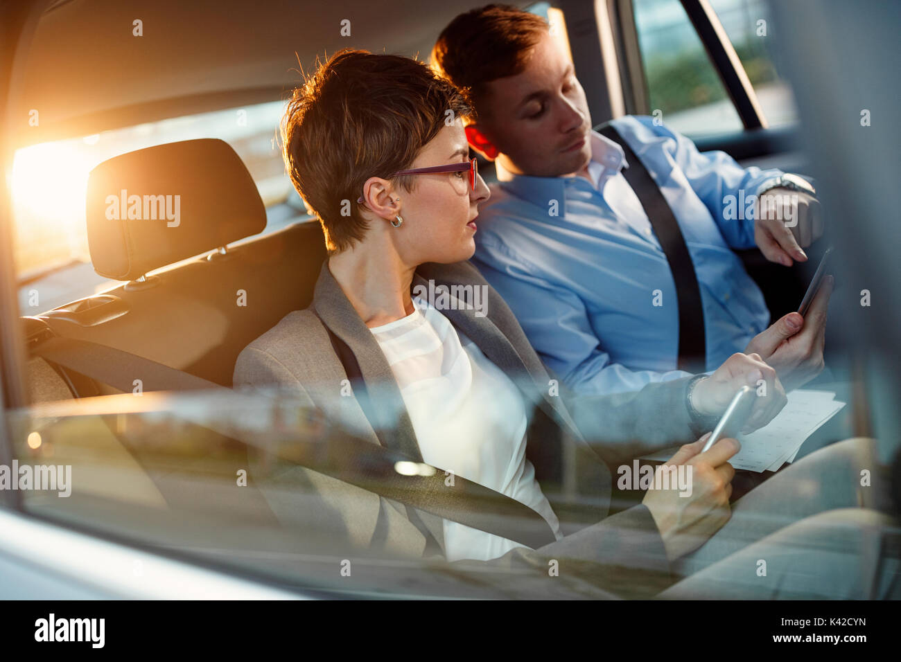 Conversation of two business people in driving car Stock Photo - Alamy