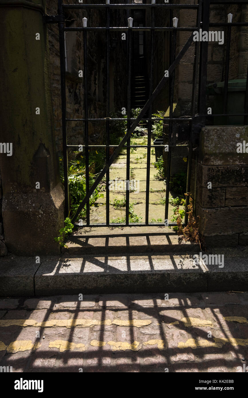 Sunlight through an alleyway between house in Hawes village, North ...