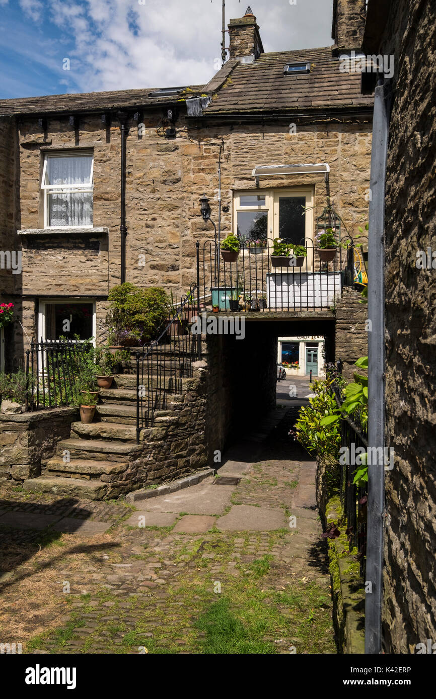 Underpass, archway, underneath a house leadin to the Pennine Way ...