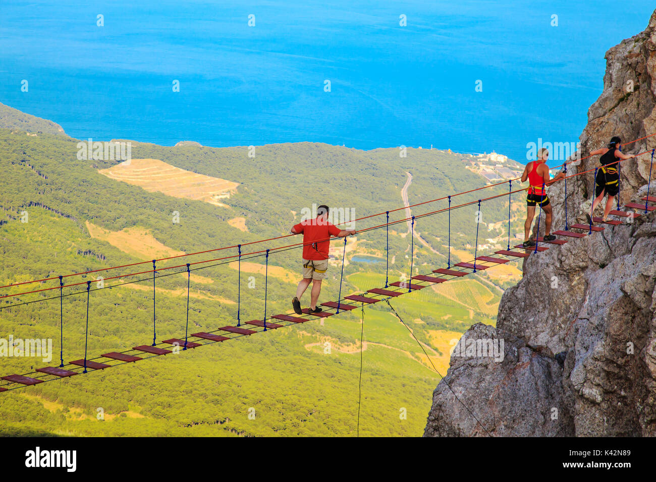 Man is walking along a suspension bridge over an abyss. Yalta, the ...