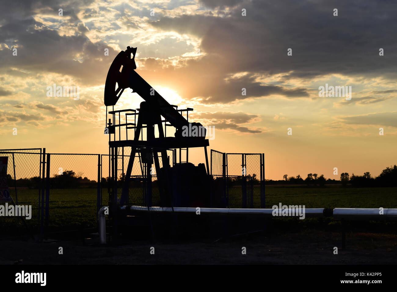 Working oil beam pump sunset hi-res stock photography and images - Alamy