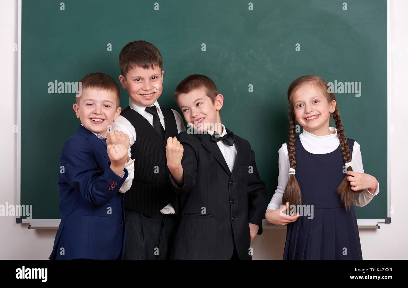 group pupil as a gang show knuckle, posing near blank chalkboard ...