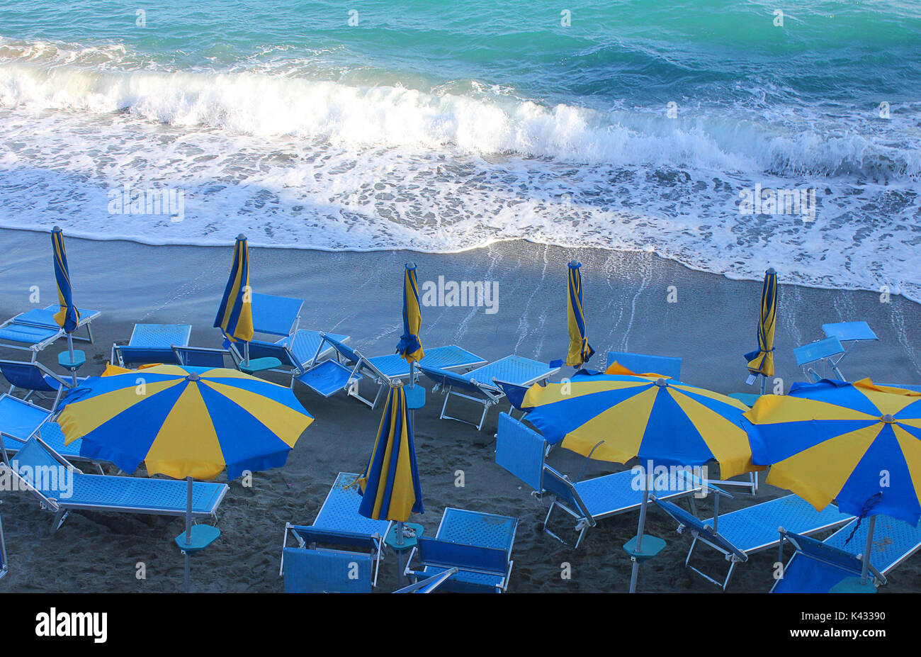 some beach umbrellas and deck chairs on the beach Stock Photo - Alamy