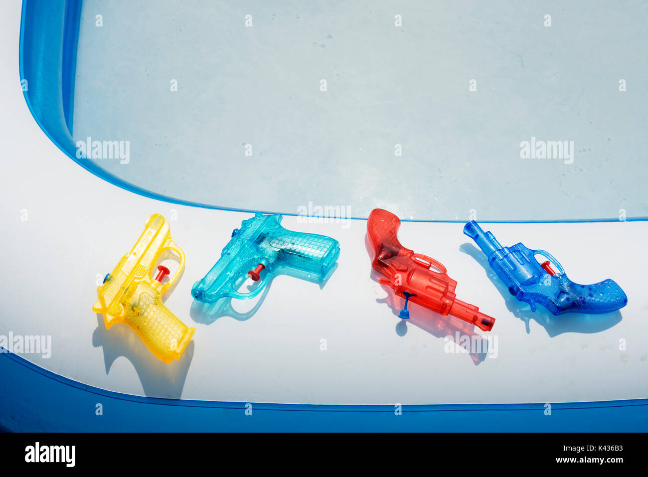 water pistols beside paddling pool Stock Photo - Alamy