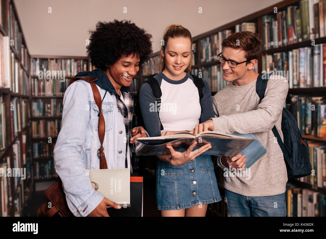 Group of college students discussing in the library. university ...