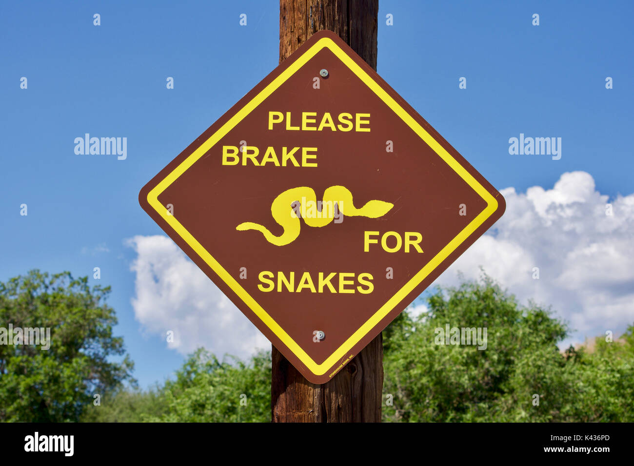 PLEASE BREAK FOR SNAKES caution sign on Colorado bike trail Stock Photo ...