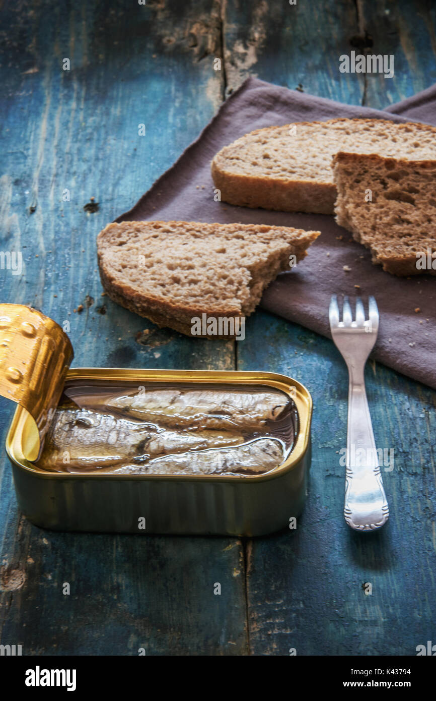 Top view of the homemade whole grain bread and canned fish on the ...
