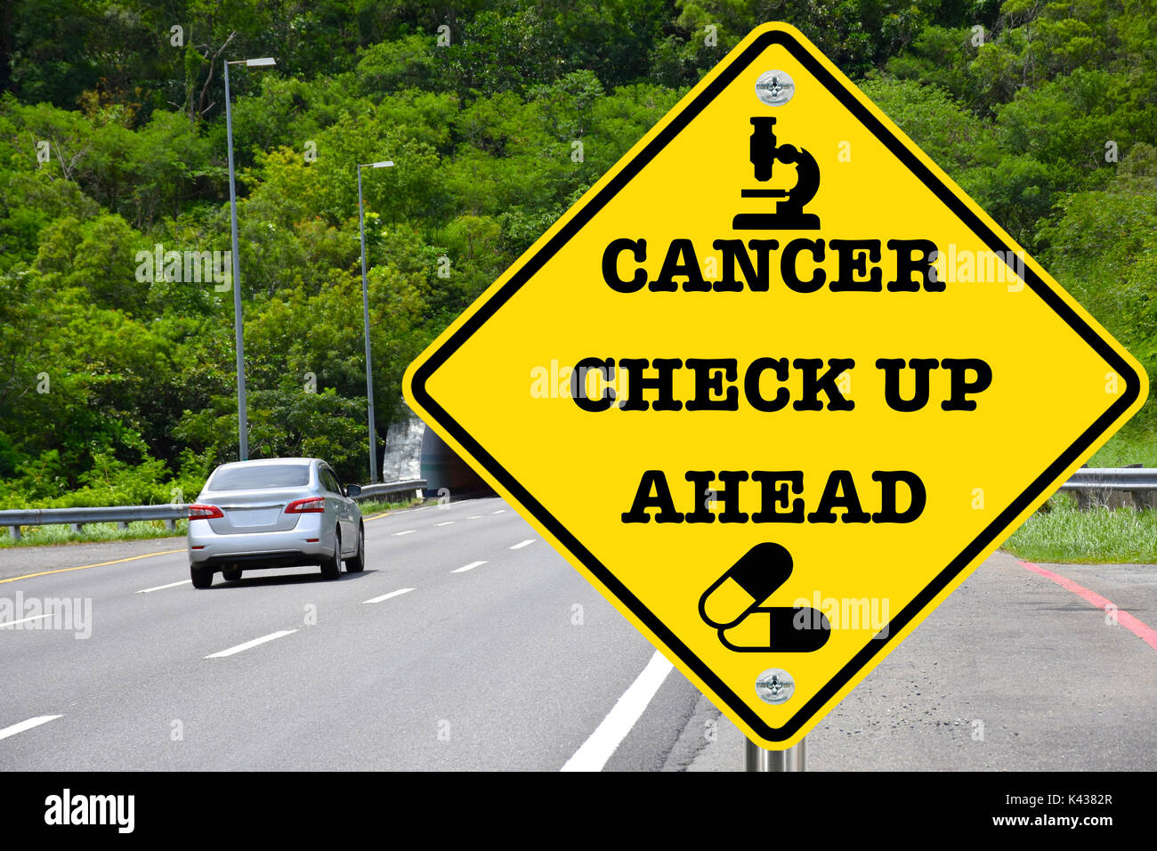 Cancer check up ahead, yellow road warning sign Stock Photo - Alamy