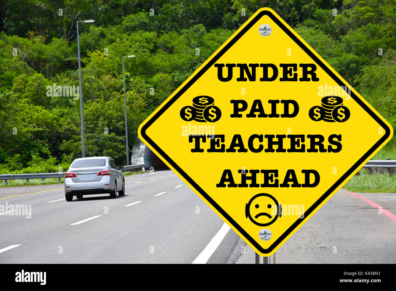 Under paid teachers ahead yellow warning road sign Stock Photo - Alamy